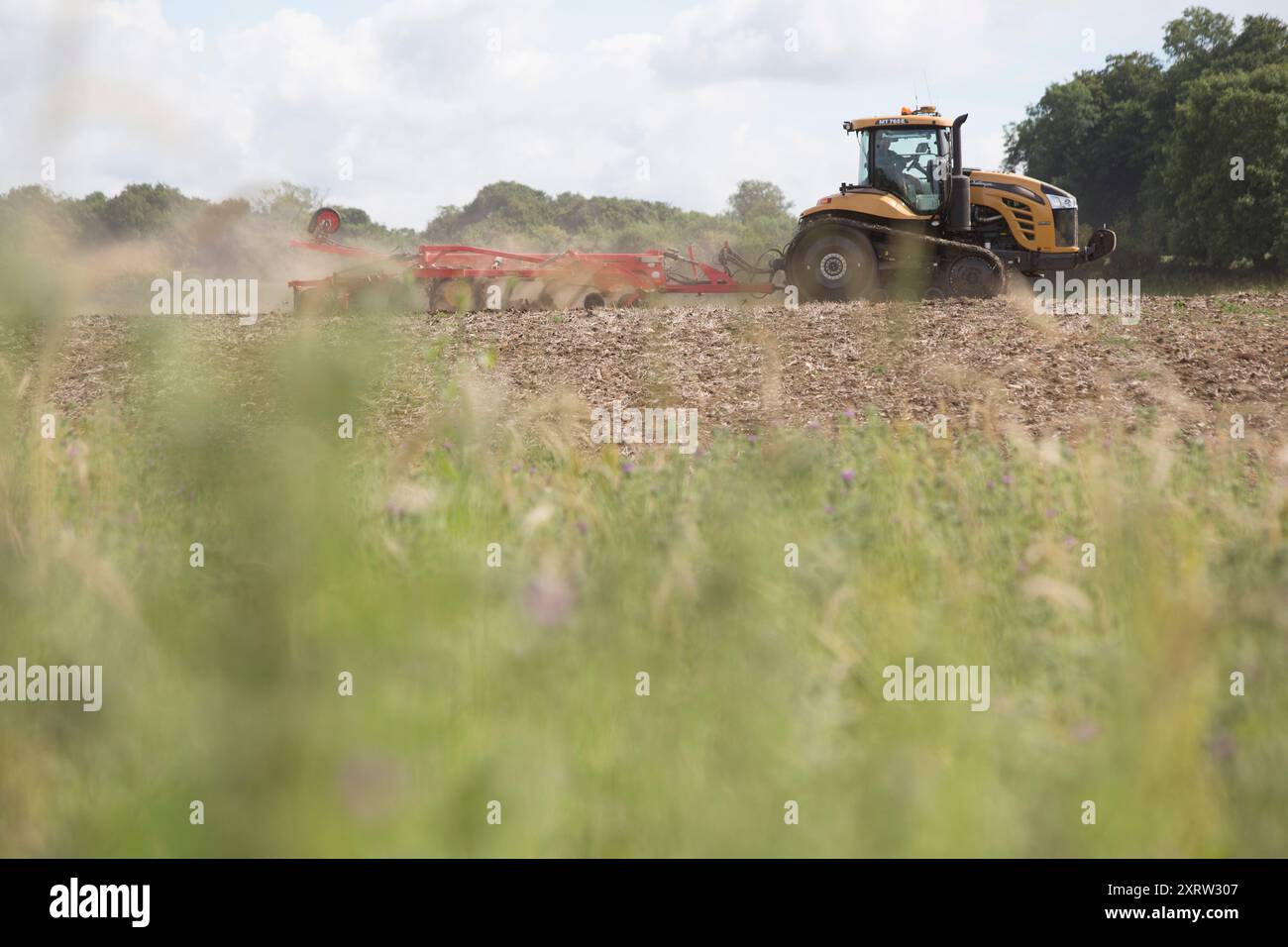 Tractors spreading muck and ploughing it in on a farmer's field Stock ...