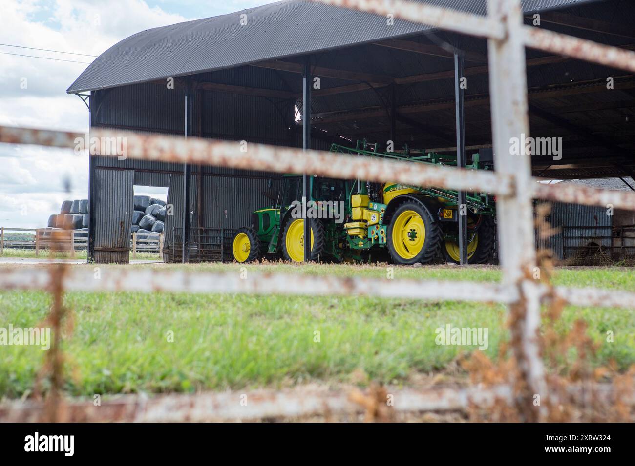 An old tractor stored in a half open barn on a farm in the UK Stock ...