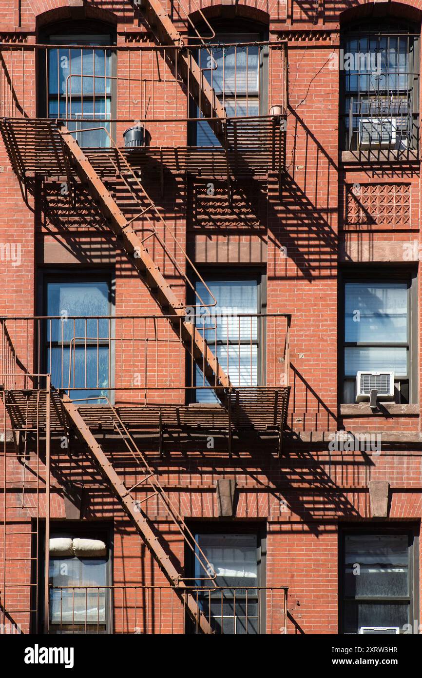 Fire escape ladders on the exterior of New York City apartments in a ...