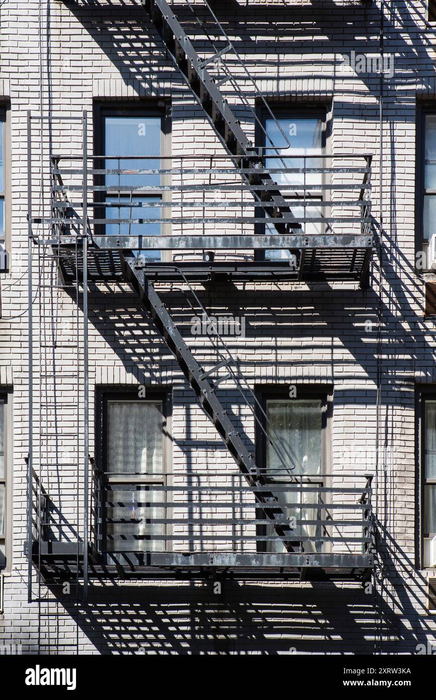 Fire escape ladders on the exterior of New York City apartments in a ...