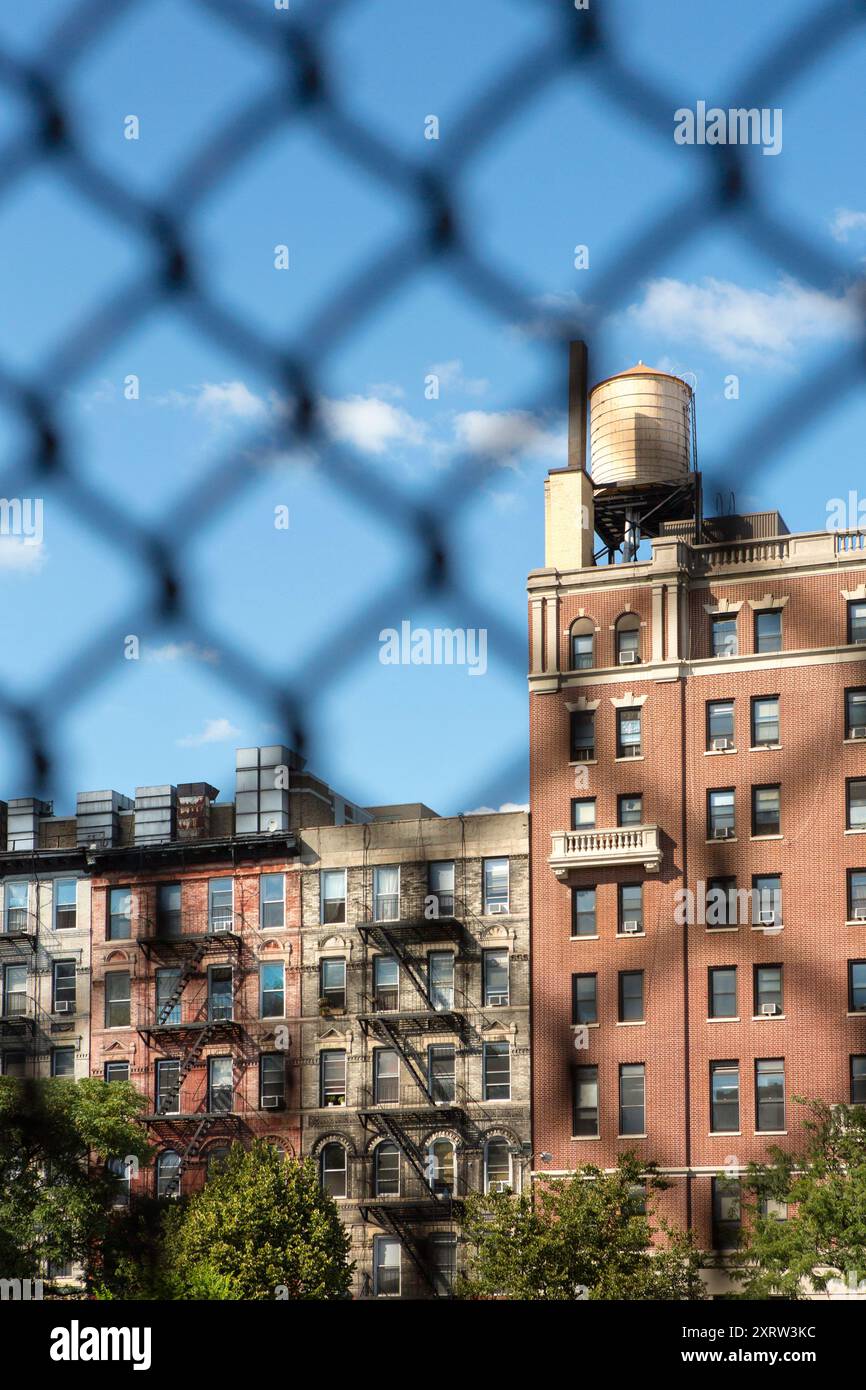 Fire escape ladders on the exterior of New York City apartments in a ...