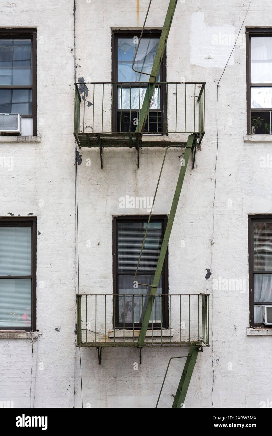 Fire escape ladders on the exterior of New York City apartments in a ...