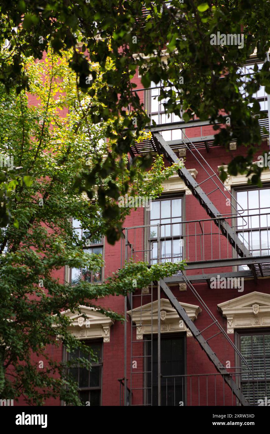 Fire escape ladders on the exterior of New York City apartments in a ...