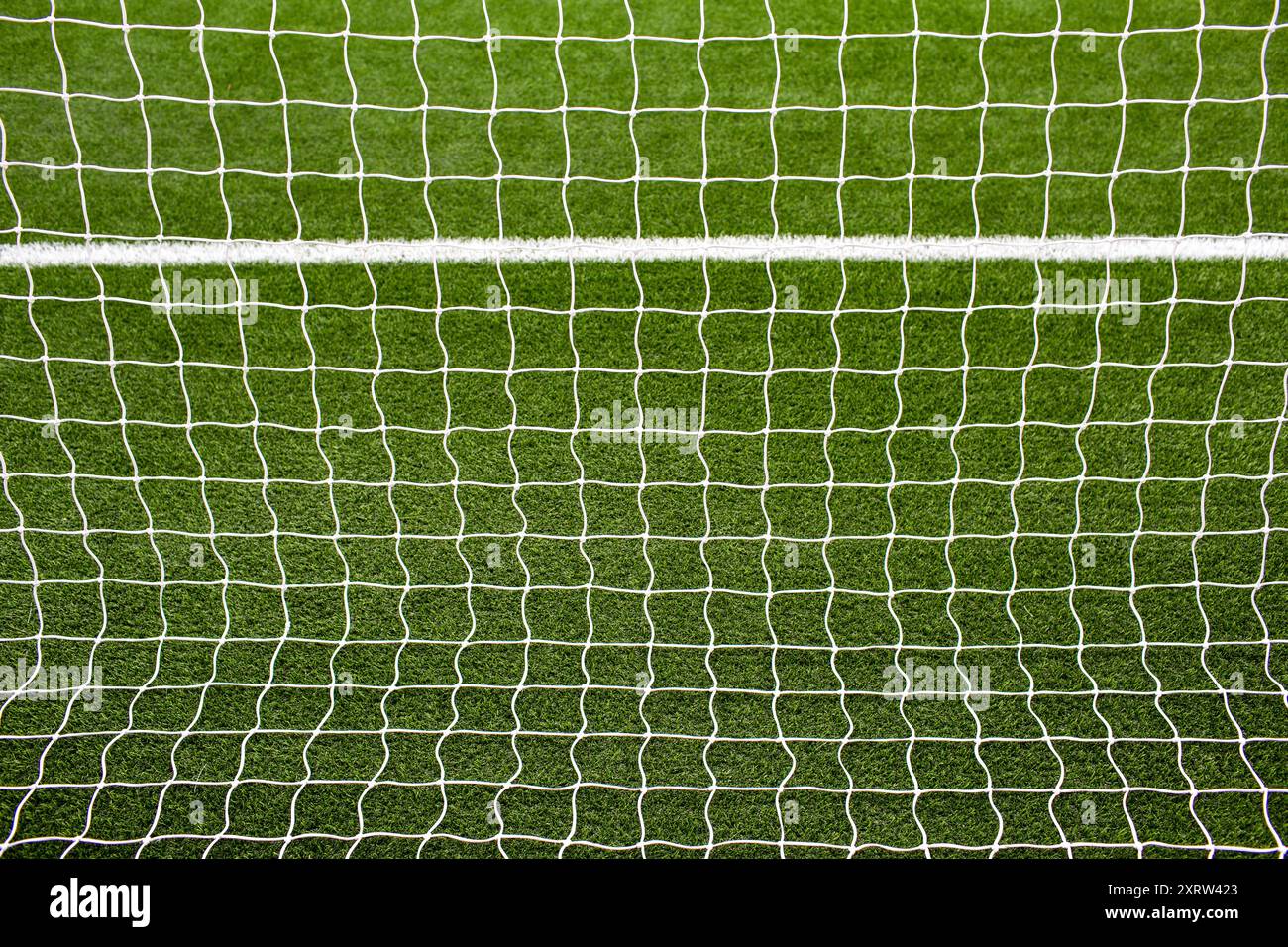 A new artificial sports pitch with white lines in the plastic grass ...