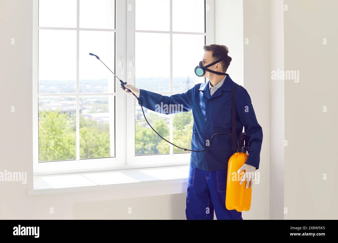 Man worker disinfecting window in apartments or doing pest control with ...