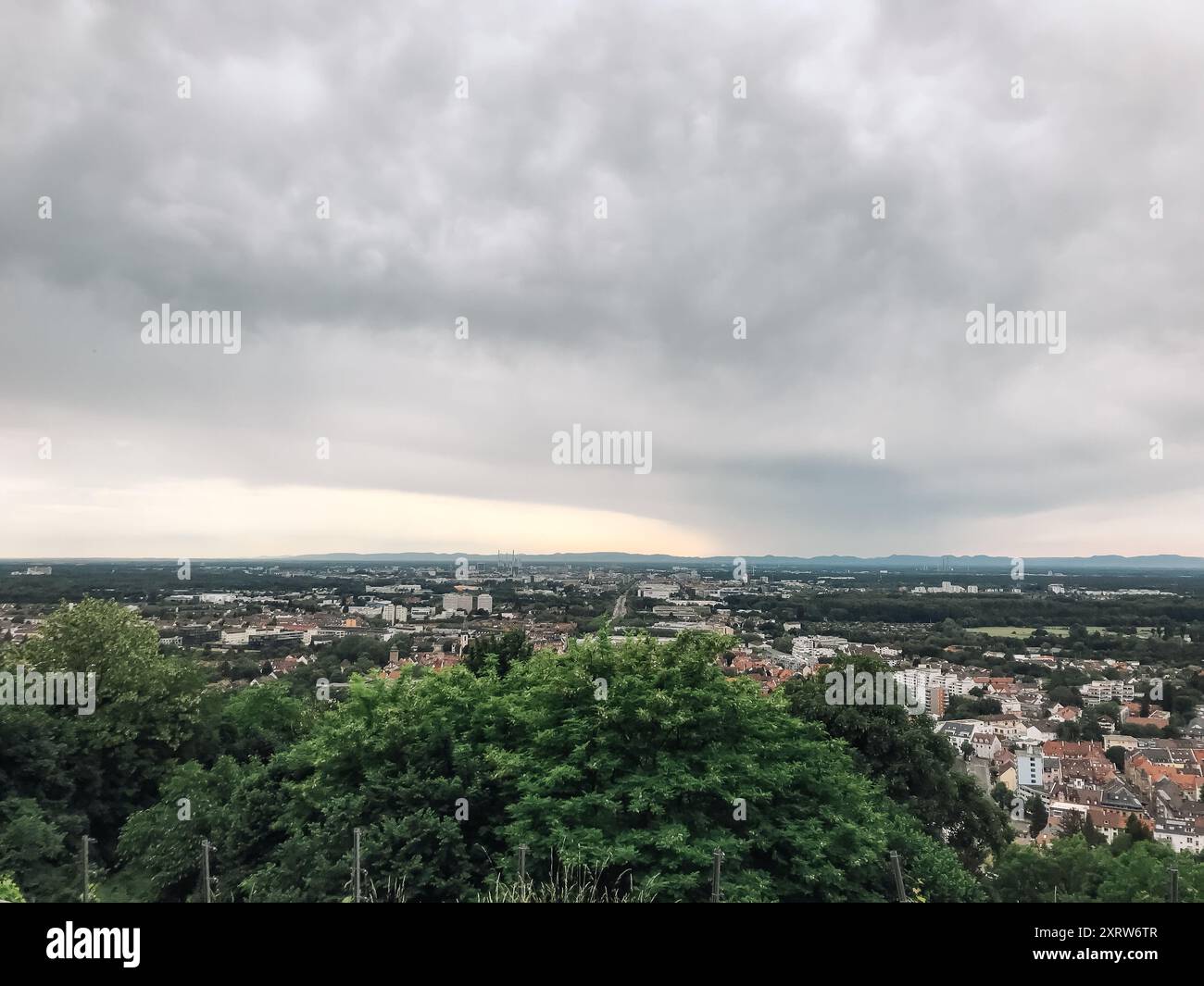 A city skyline is visible in the distance, with a cloudy sky overhead ...