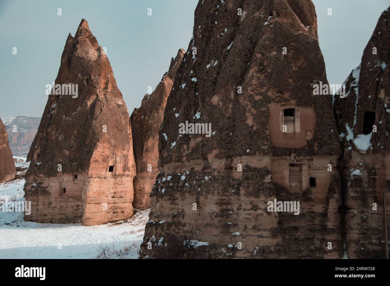 Snow-covered fairy chimneys in Cappadocia,Turkey, with ancient cave ...