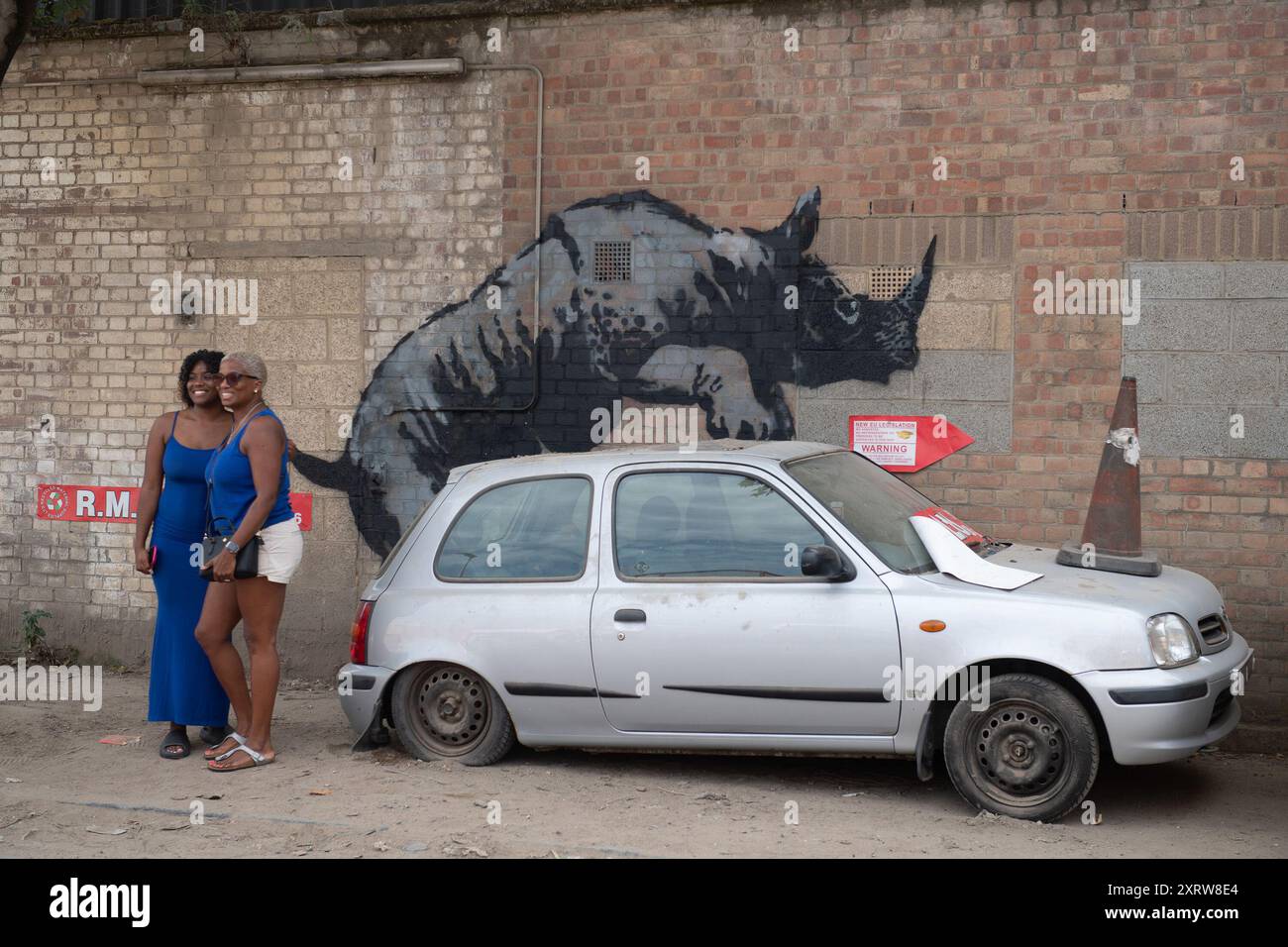 London, UK. 12 Aug 2024. People pose for photos with Street Artist ...