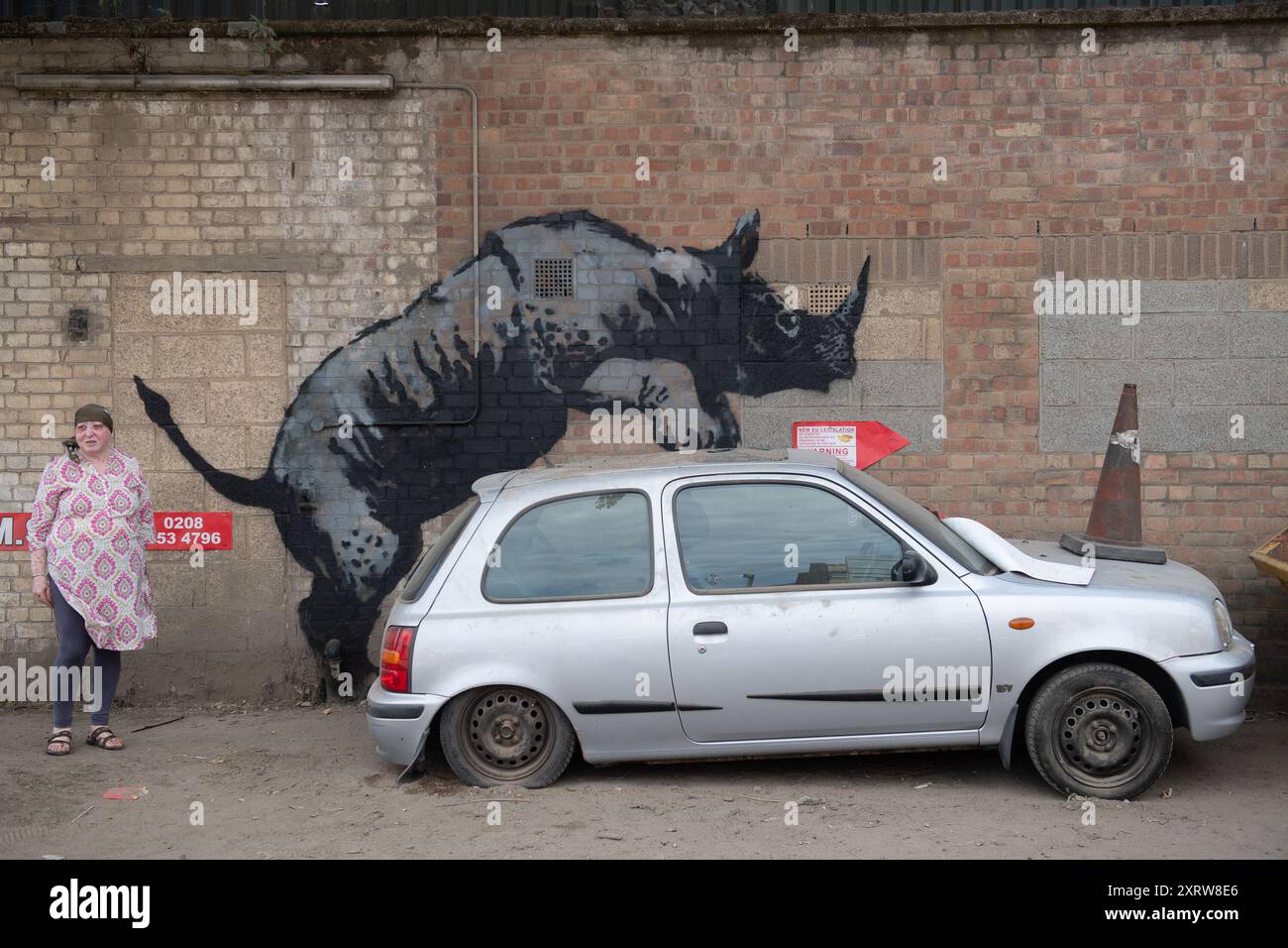 London, UK. 12 Aug 2024. People pose for photos with Street Artist ...
