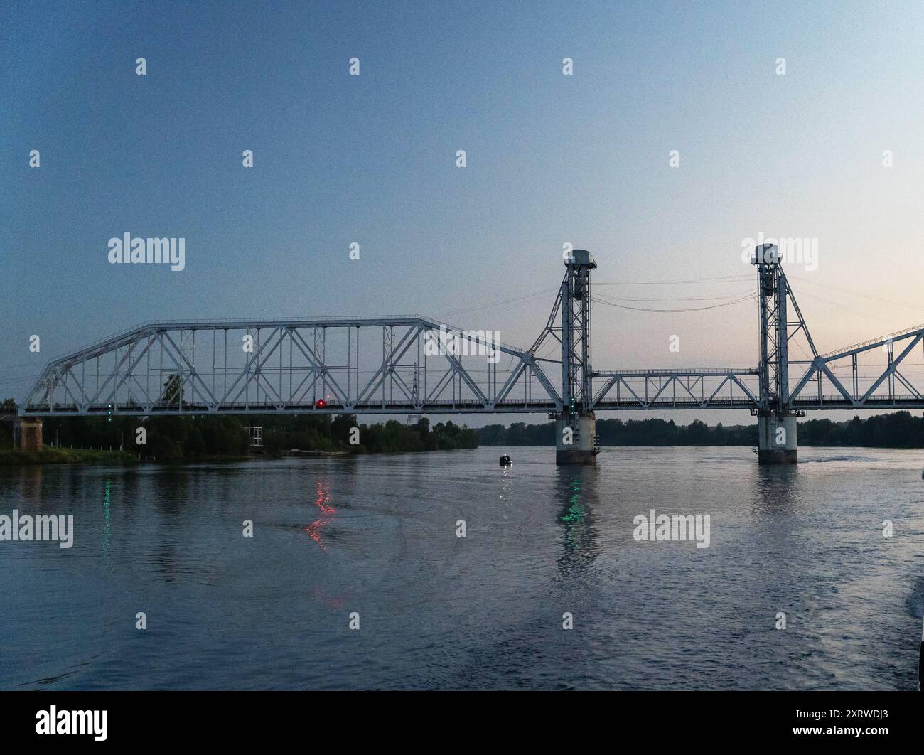 The bridge rises above tranquil waters as day turns to night ...