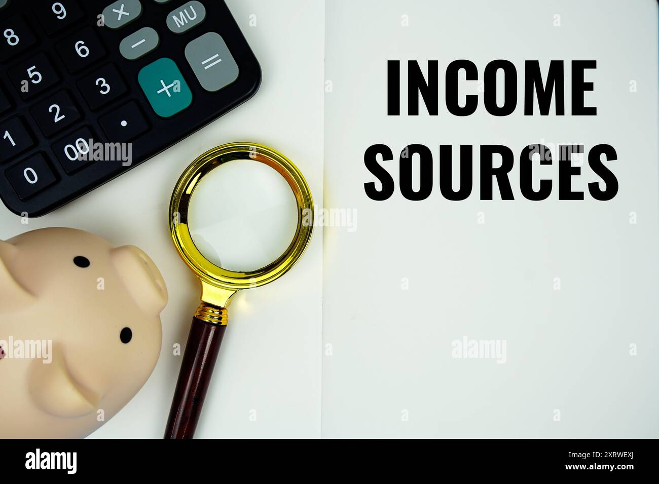 Income sources text message written on note page with calculator, piggy ...