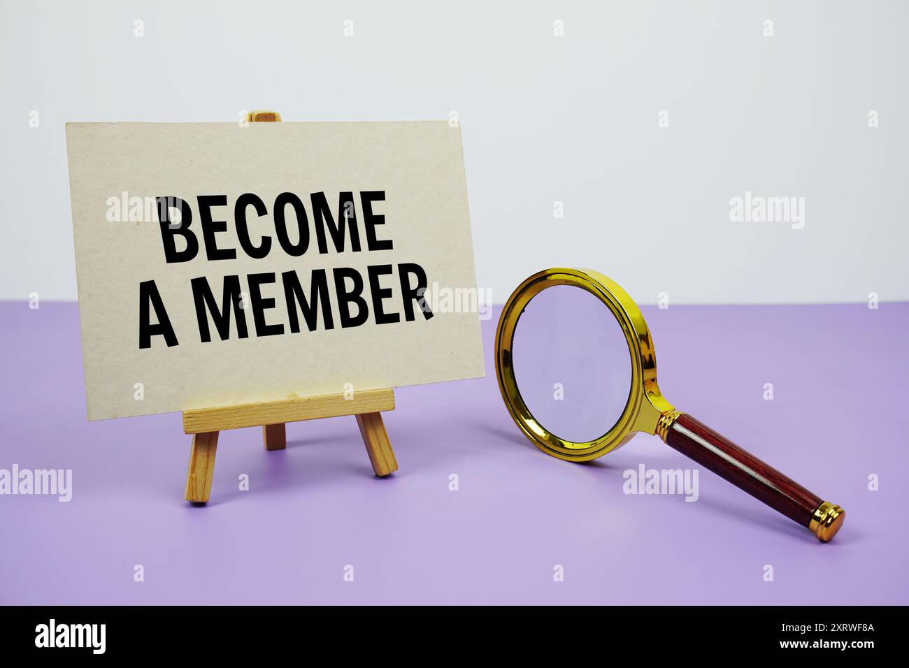 Become a member text on paper card with magnifying glass on purple ...