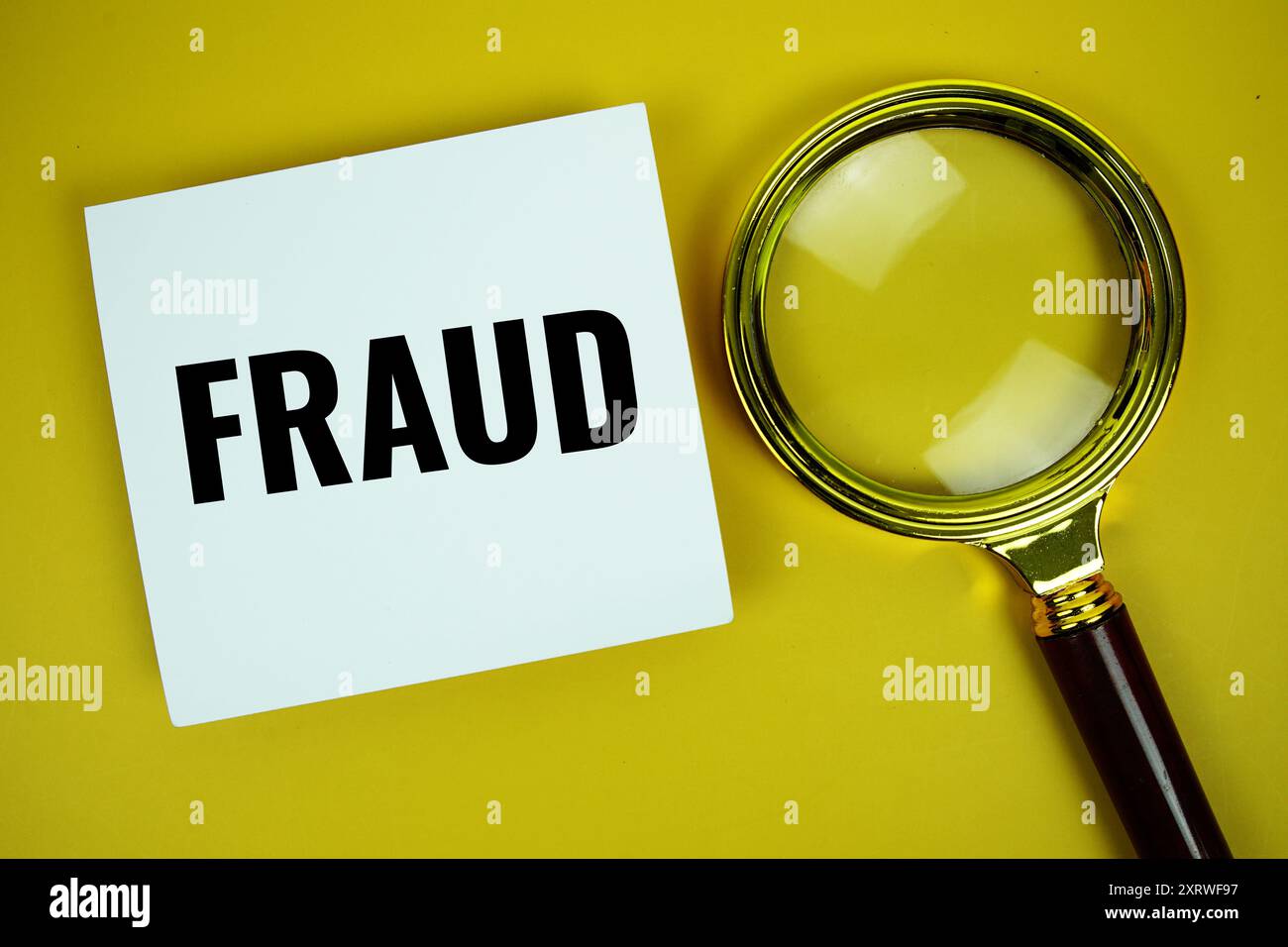 Fraud text message written on paper note with magnifying glass top view ...