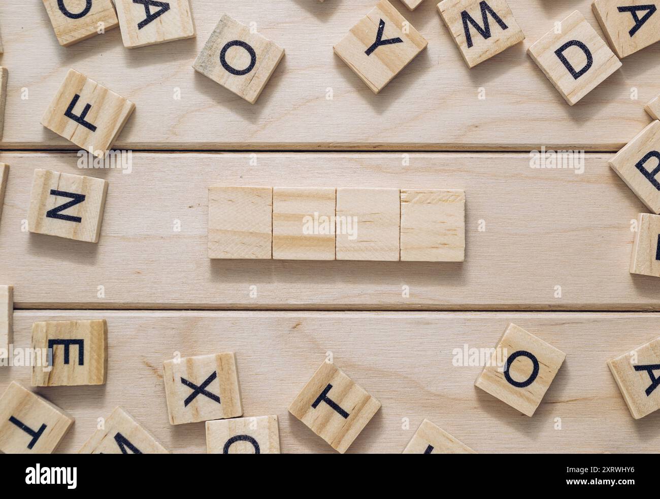 A wooden board with a crossword puzzle on it. The puzzle is made up of ...
