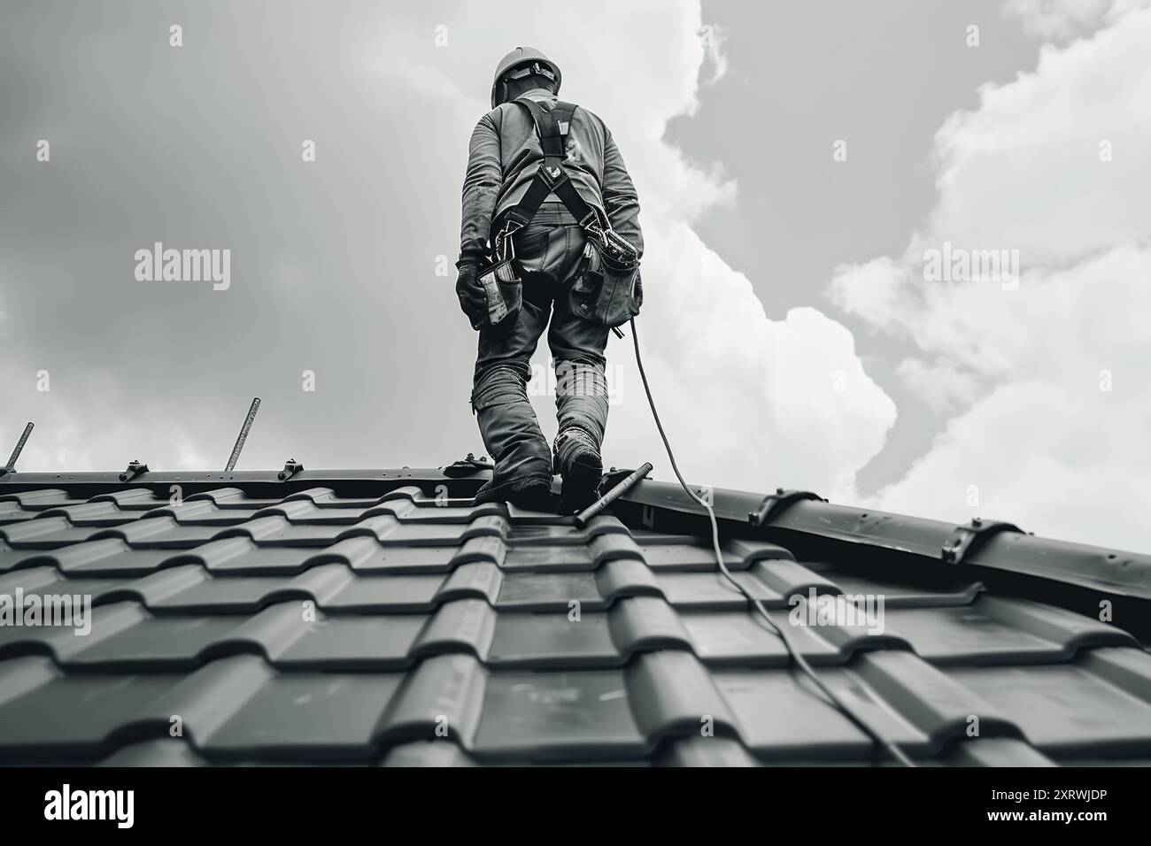 Construction worker wearing safety harness and safety line working on ...