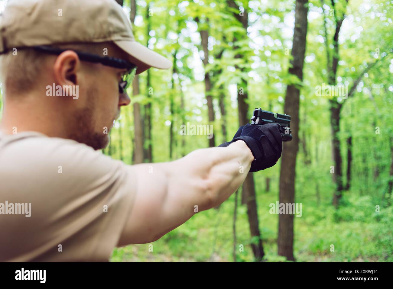 guy with arms in the woods is aiming and posing at the camera Stock ...