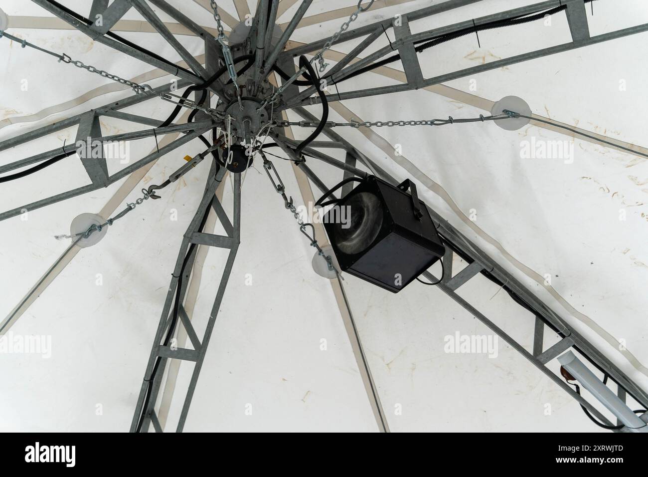 A distinctive lighting fixture hangs from a structural framework Stock ...