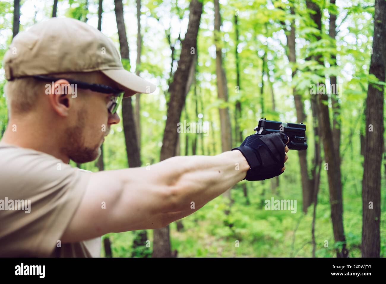 guy with arms in the woods is aiming and posing at the camera Stock ...
