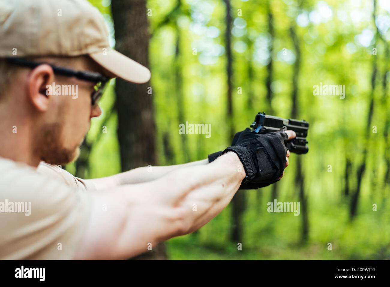 guy with arms in the woods is aiming and posing at the camera Stock ...