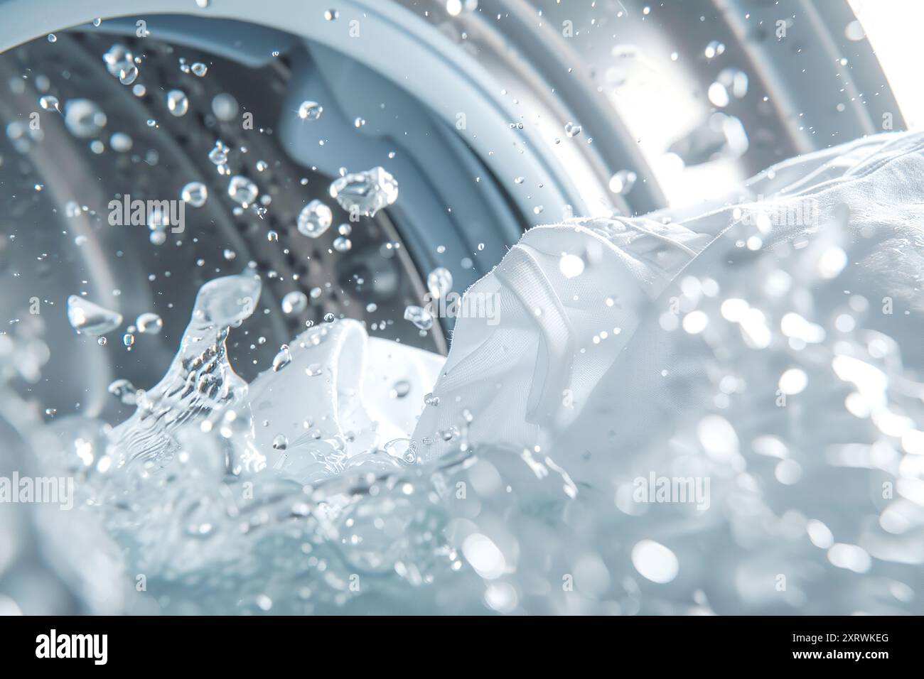 Washing machine drum with water and clothes, view of a washing machine ...
