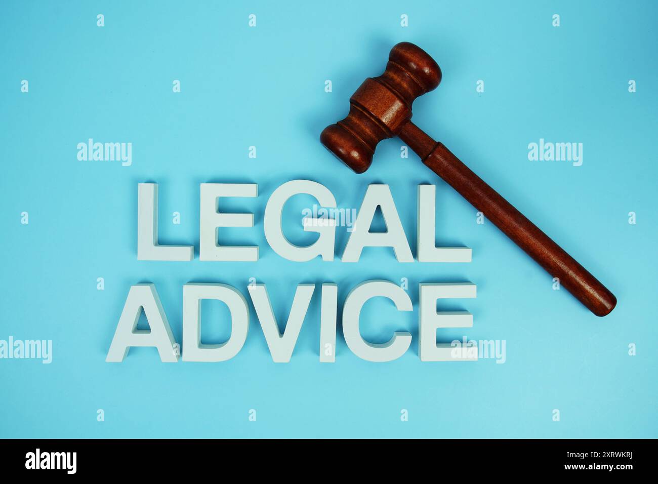 Legal Advice alphabet letters with wooden judge gavel on blue ...