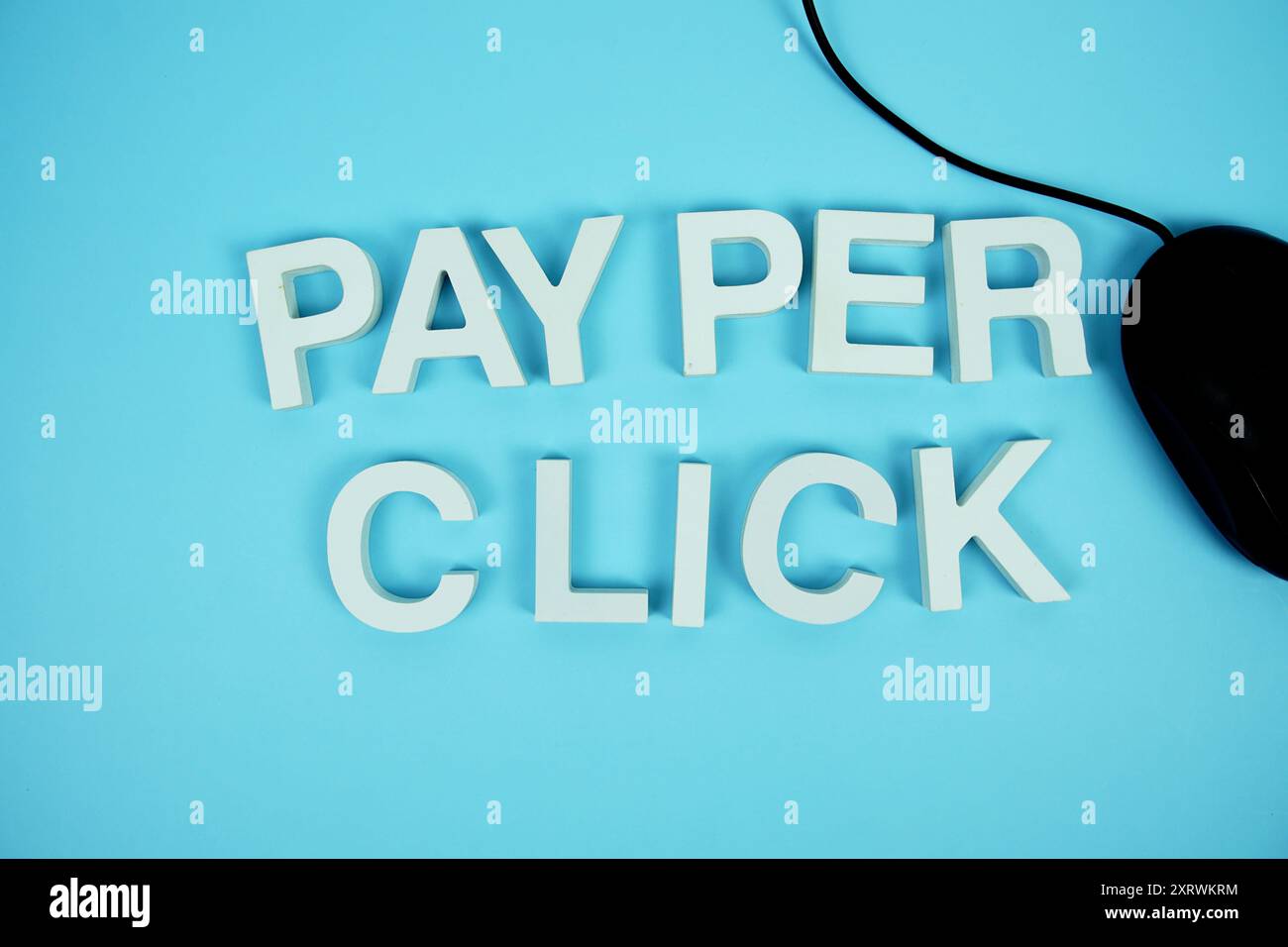 Pay Per Click alphabet letters and optical mouse top view on blue ...