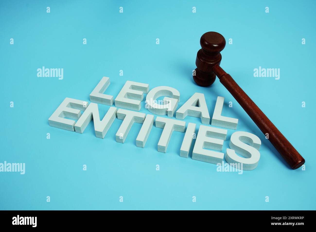Legal Entities alphabet letters with wooden judge gavel on blue ...