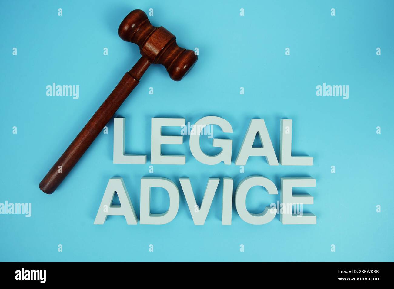 Legal Advice alphabet letters with wooden judge gavel on blue ...