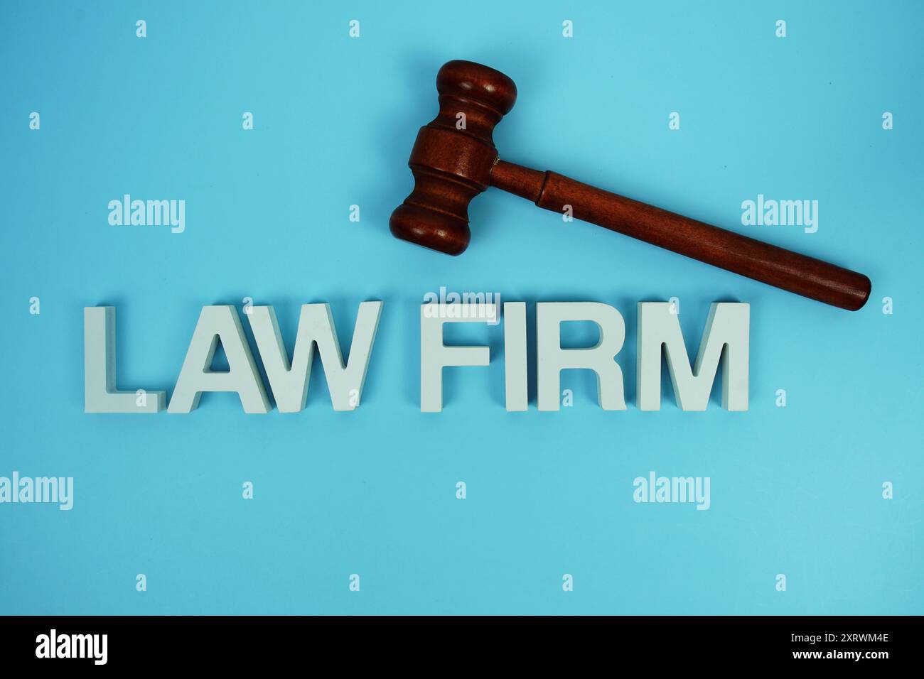 Law Firm alphabet letters with wooden judge gavel on blue background ...