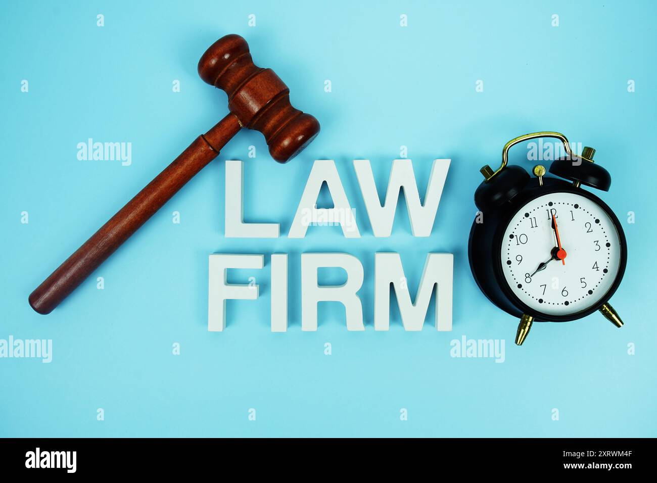 Law Firm alphabet letters with wooden judge gavel and alarm clock on ...