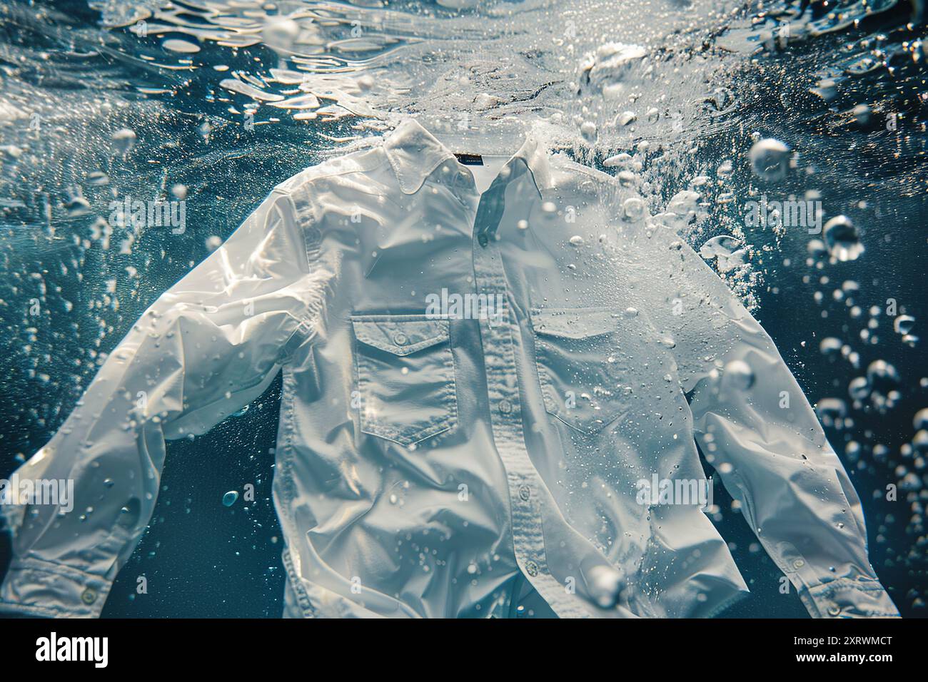 Clothes in washing machine indoors, with detergent water dissolution ...