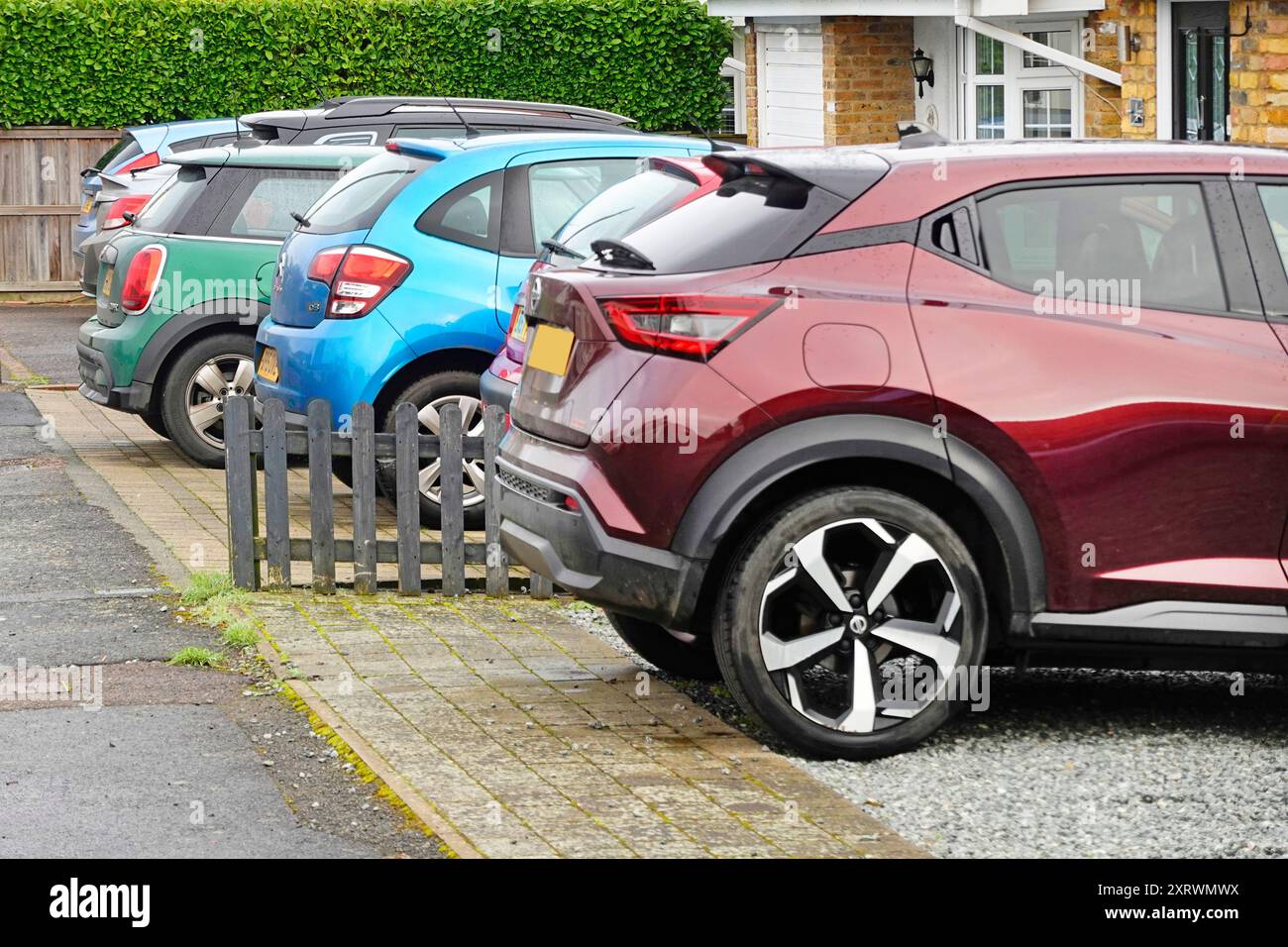 Line of assorted colours on hatchback motor cars parked on hardstanding ...