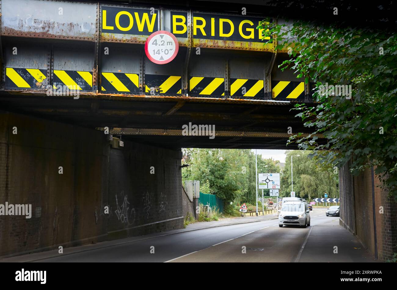 Warning about a low railway bridge over a road in Kettering, England ...