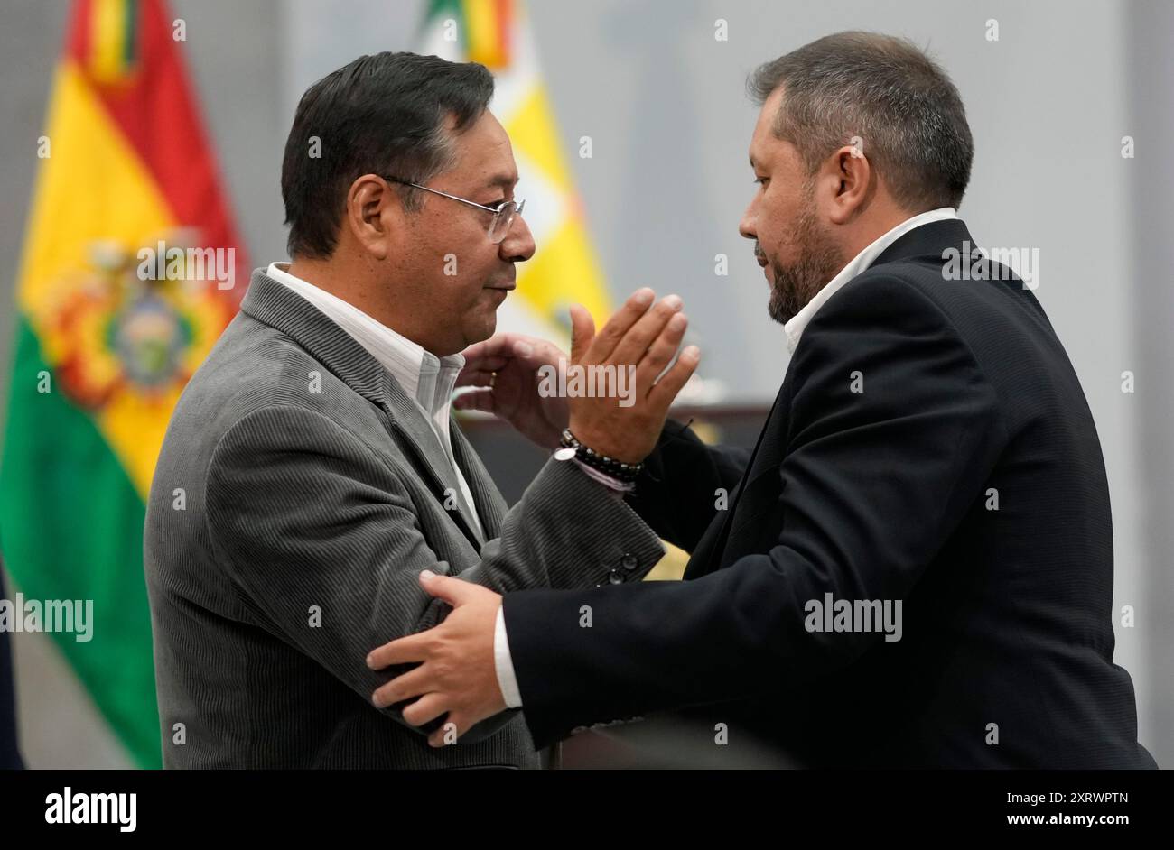 Bolivian President Luis Arce, left, embraces his newly appointed ...