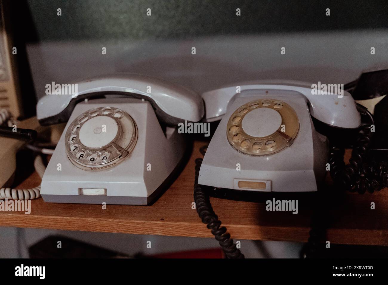 Two vintage rotary telephones sit side by side on a shelf Stock Photo ...