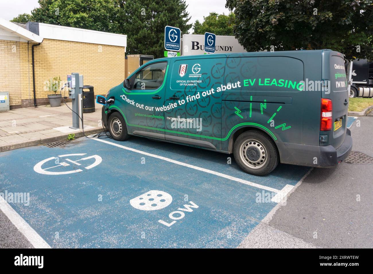 A Gridserve EV Leasing van recharging at a charging point in the car ...