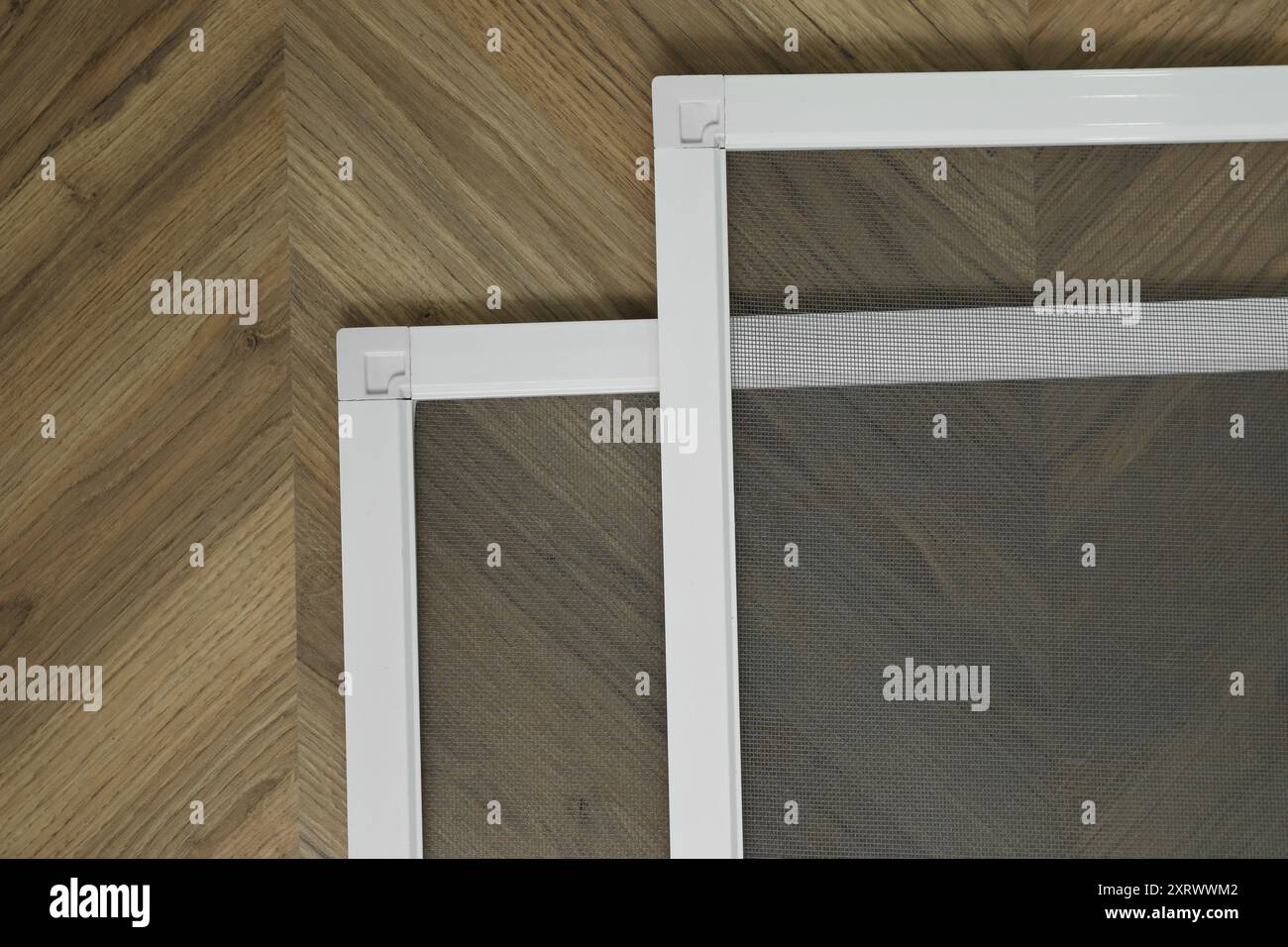 New window screens on wooden floor, flat lay Stock Photo - Alamy