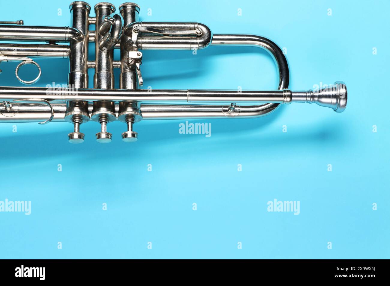One trumpet on light blue background, top view. Space for text Stock ...