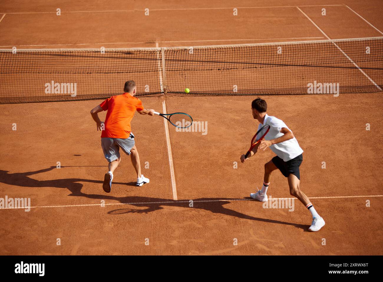 Team game on. Dynamic image of two competitive young men, tennis ...