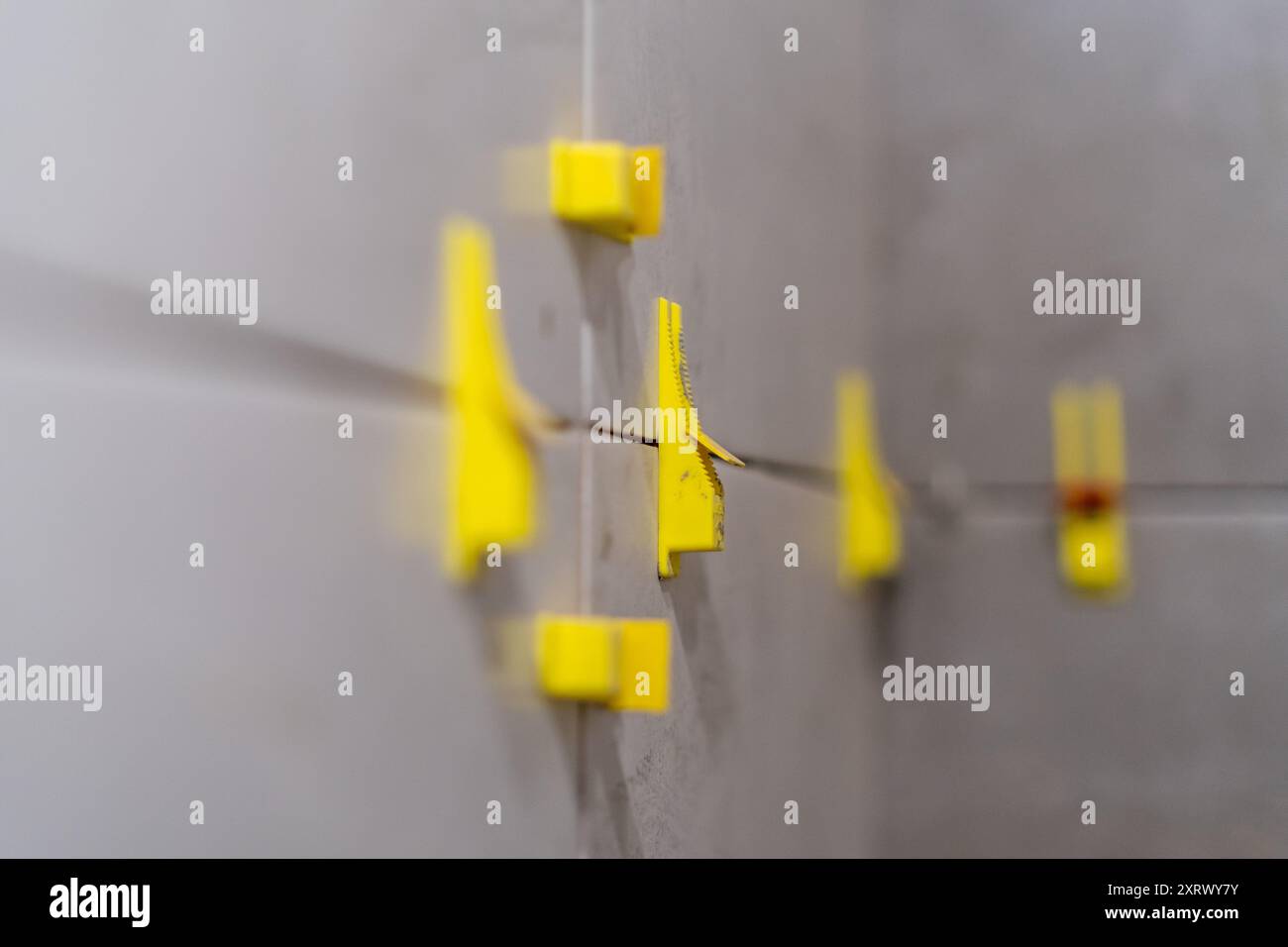 Plastic clips and wedges securing tiles in place for perfect alignment ...