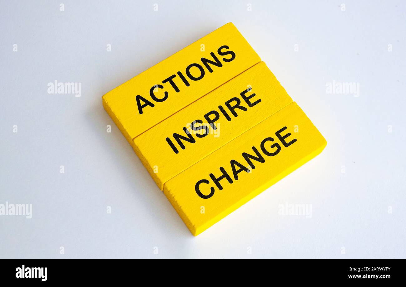 Top view of Actions Inspire Change text on yellow wooden blocks on ...