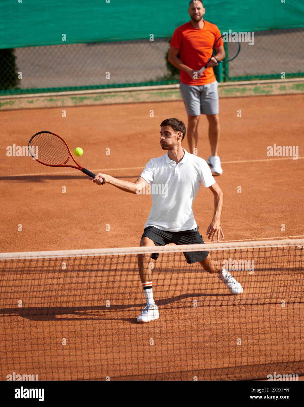 Competitive moment on court. Two men, professional tennis players in ...