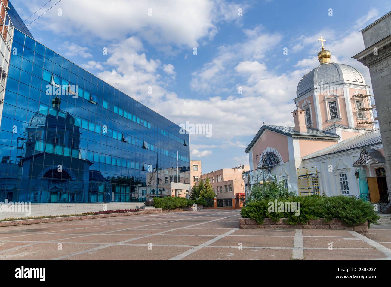 The modern glass building and reflection of Russian cathedral in ...