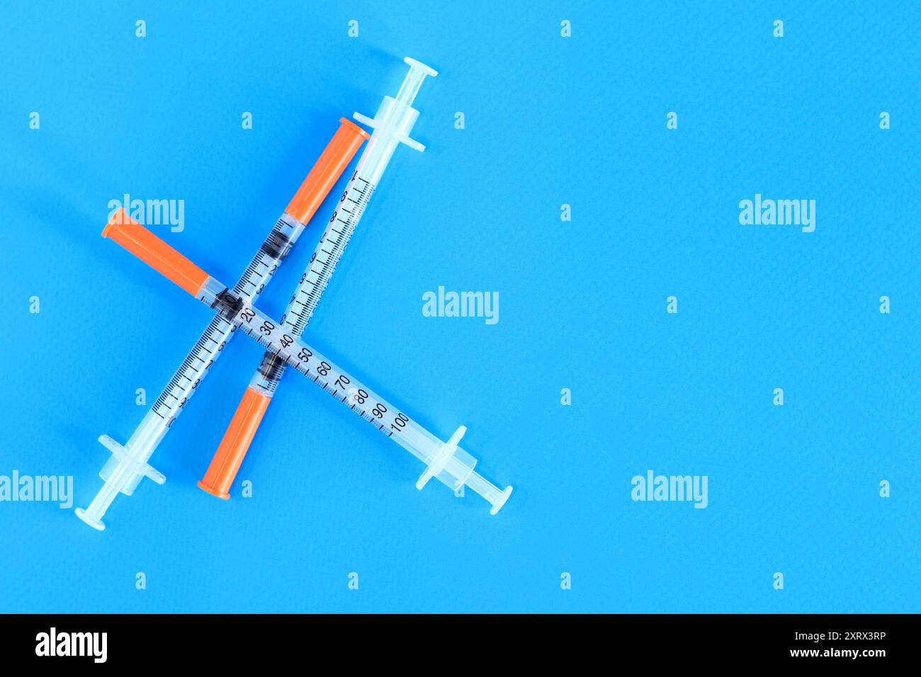 Insulin syringes on a blue background. Diabetes treatment. Medicine and ...