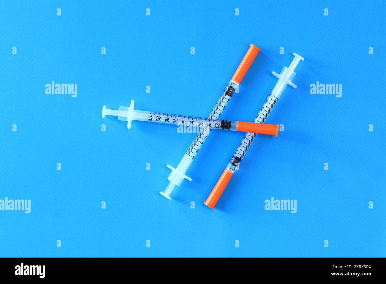 Insulin syringes on a blue background. Diabetes treatment. Medicine and ...