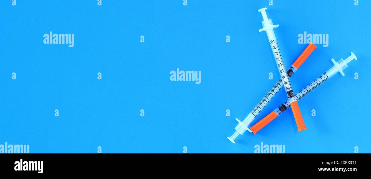 Insulin syringes on a blue background. Diabetes treatment. Medicine and ...