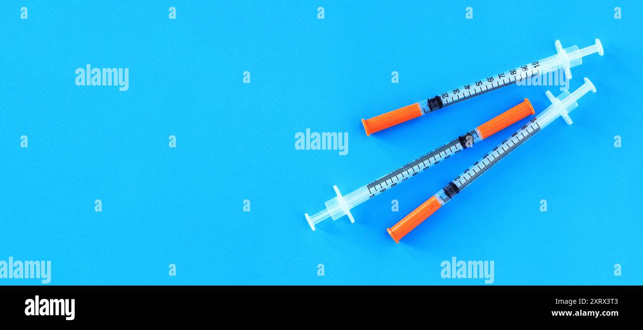 Insulin syringes on a blue background. Diabetes treatment. Medicine and ...