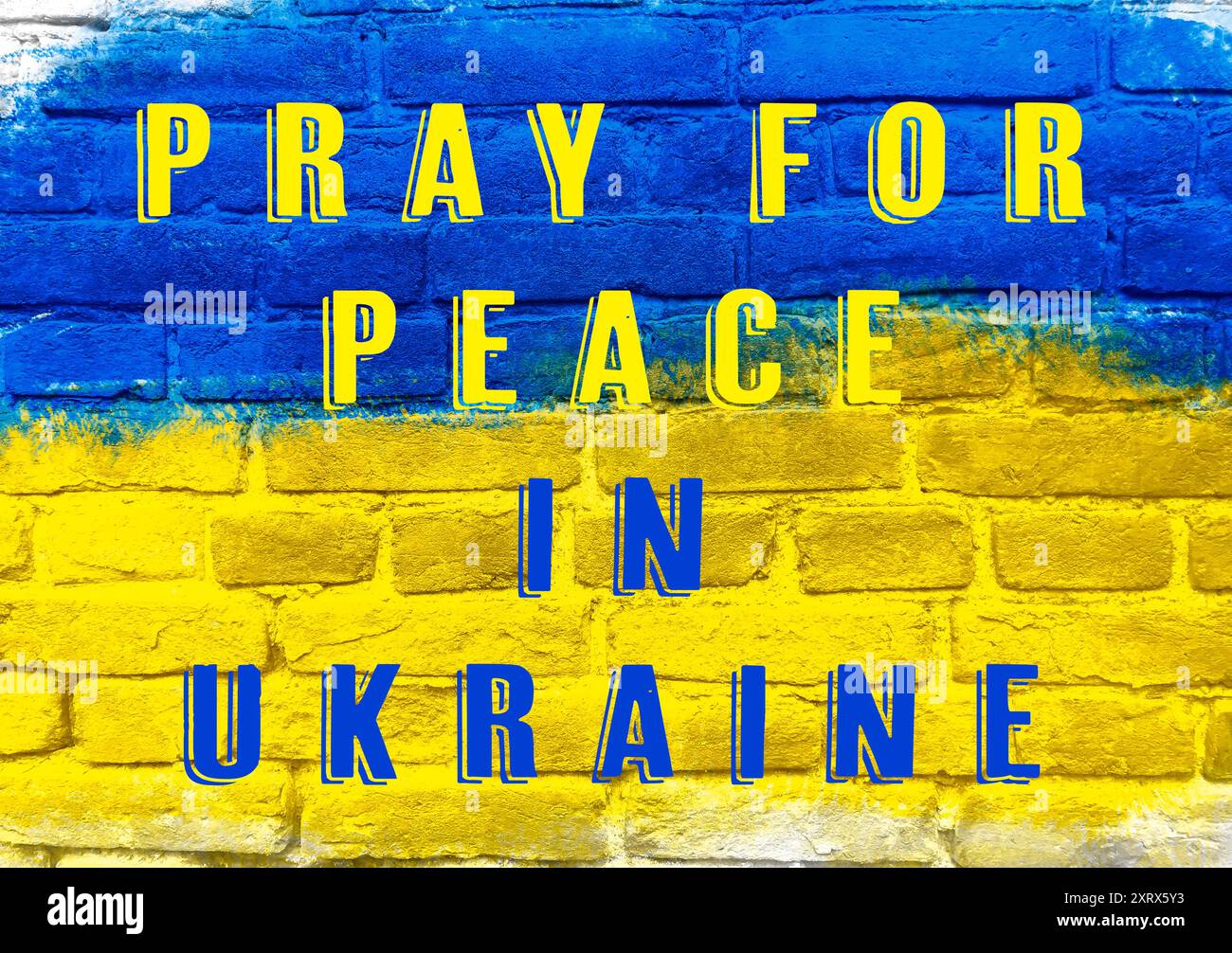 A blue and yellow sign that says pray for peace in Ukraine. The sign is ...