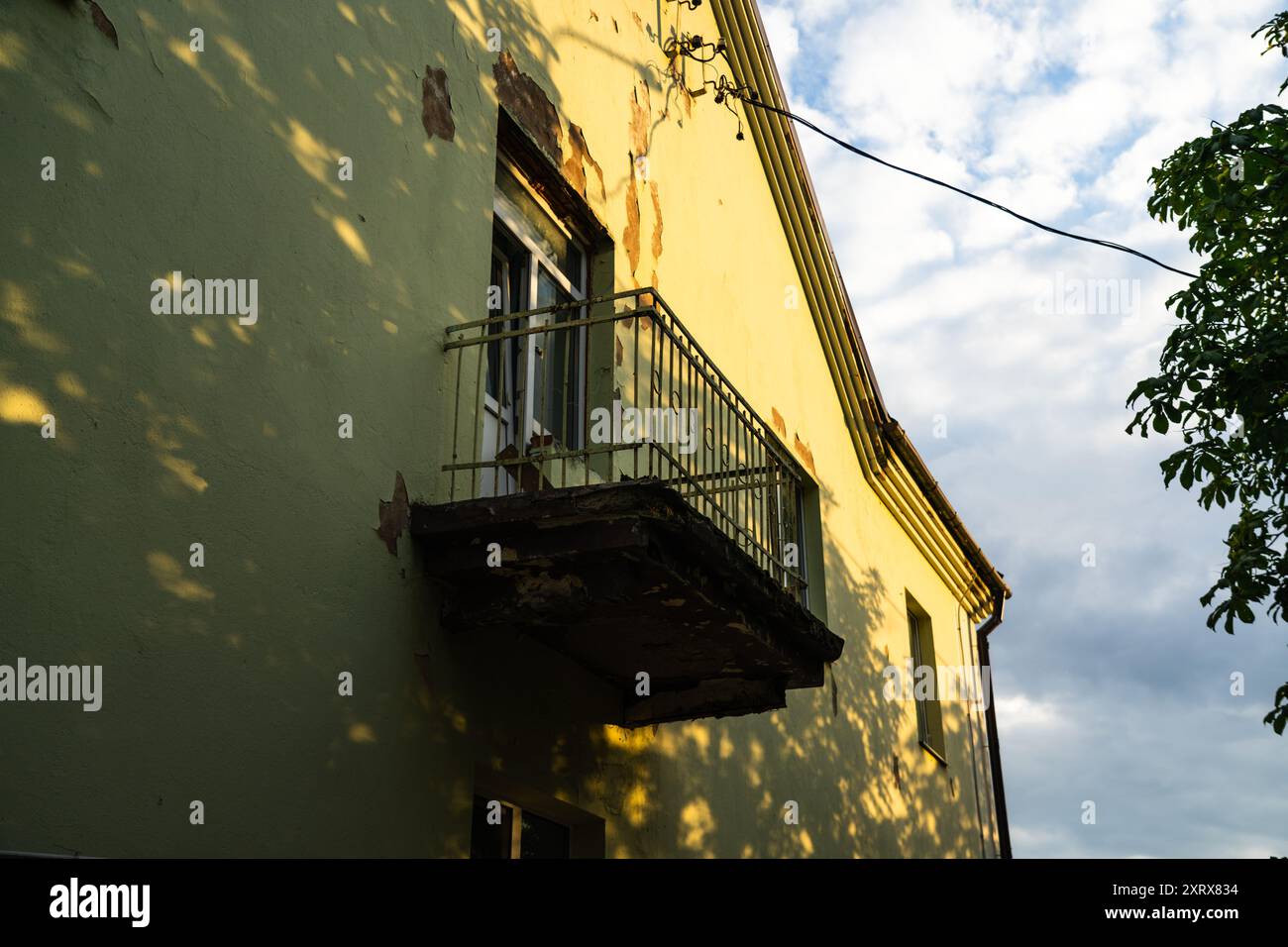 Balcony with access to the street, in an old house, with peeling ...