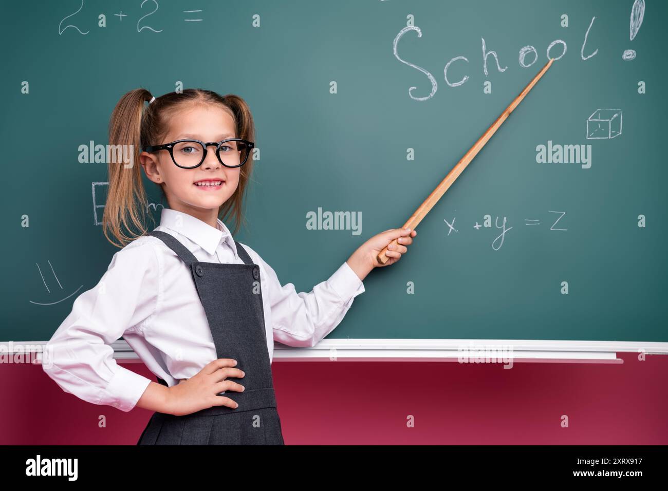 Photo of charming little pupil girl hold pointer stick teach explain ...